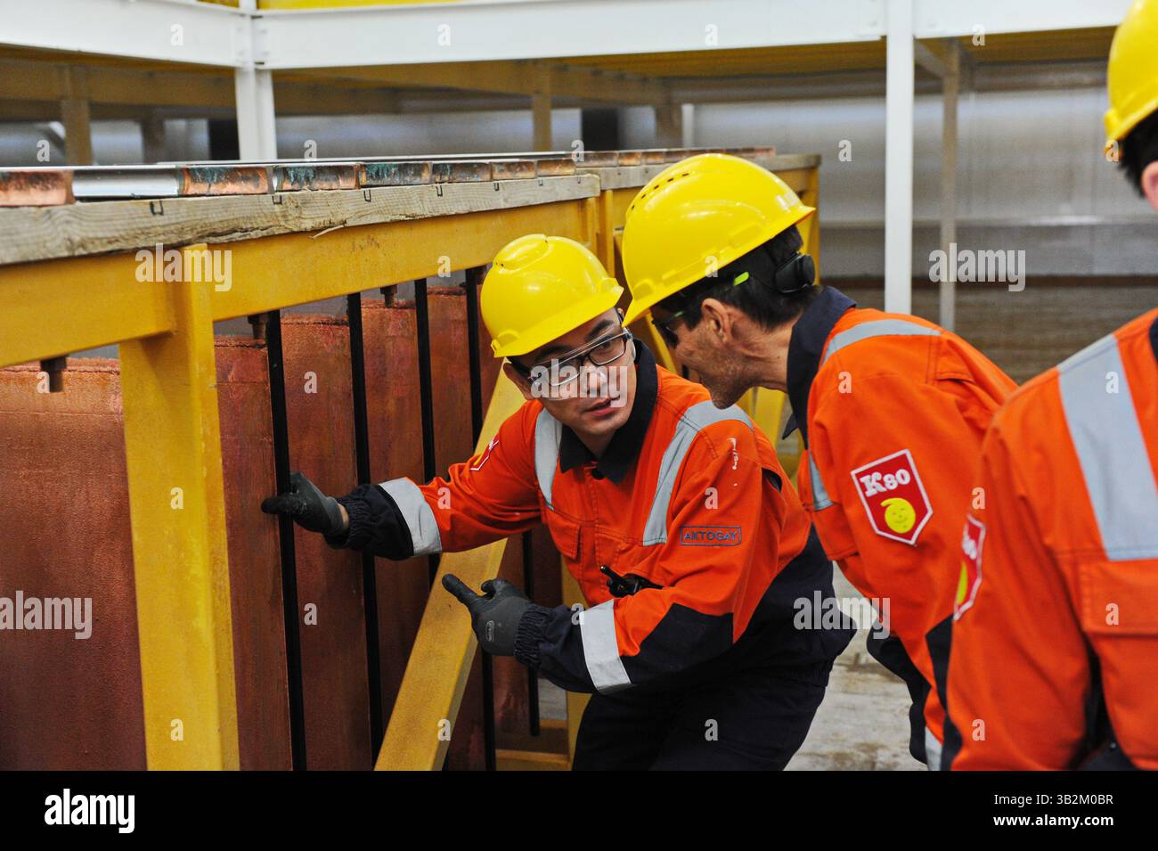 Workers fix and prepare layers of cathode copper at the plant Stock ...