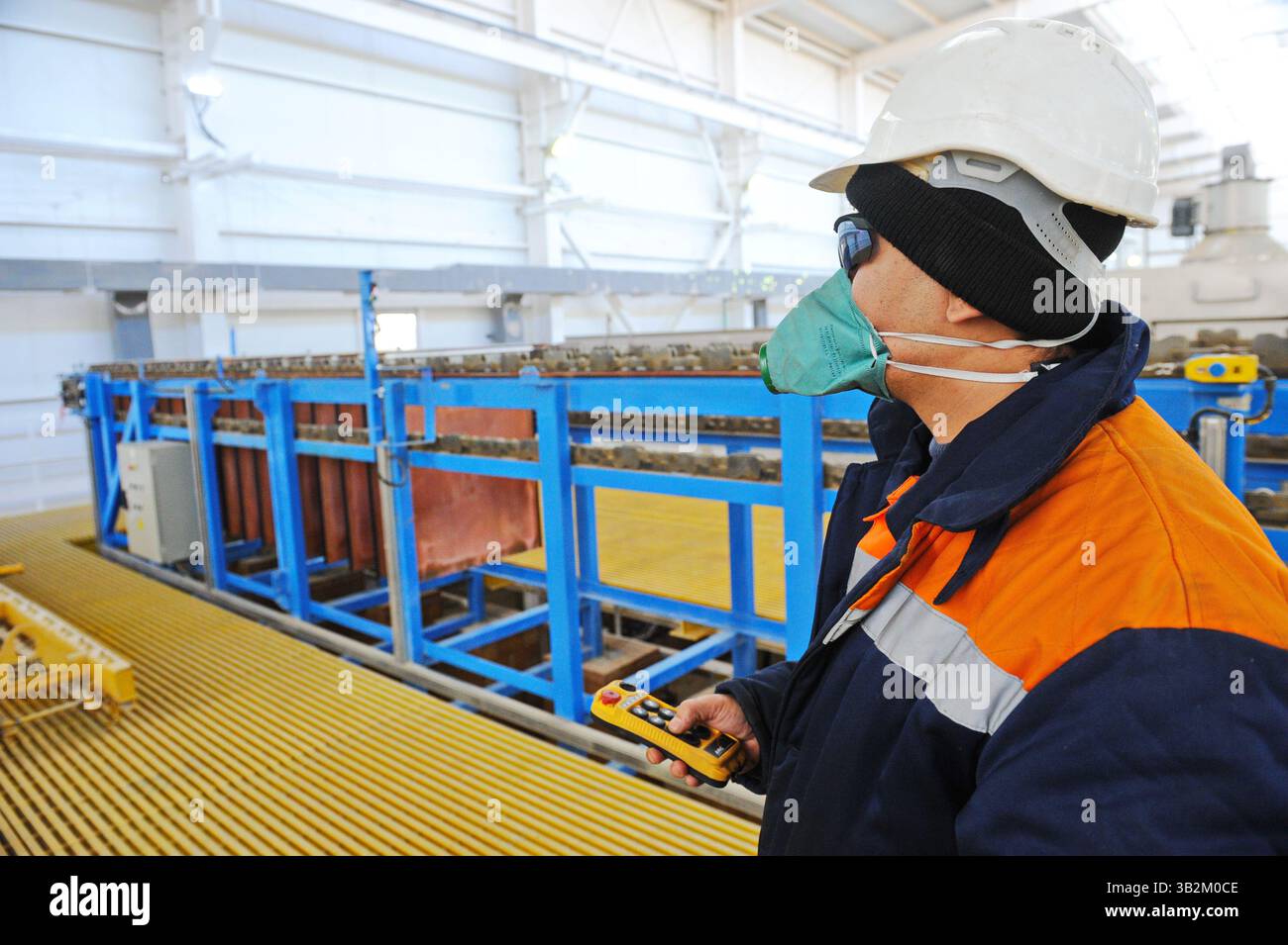 Workers fix and prepare layers of cathode copper at the plant Stock ...