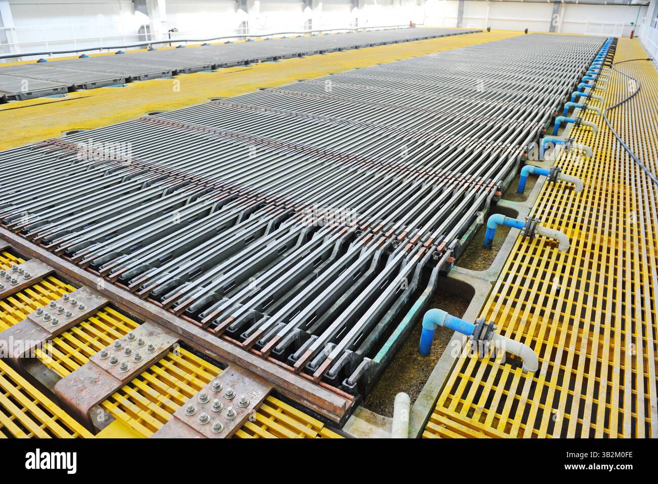 The metal hoists are arranged in a row in the copper cathode cleaning ...