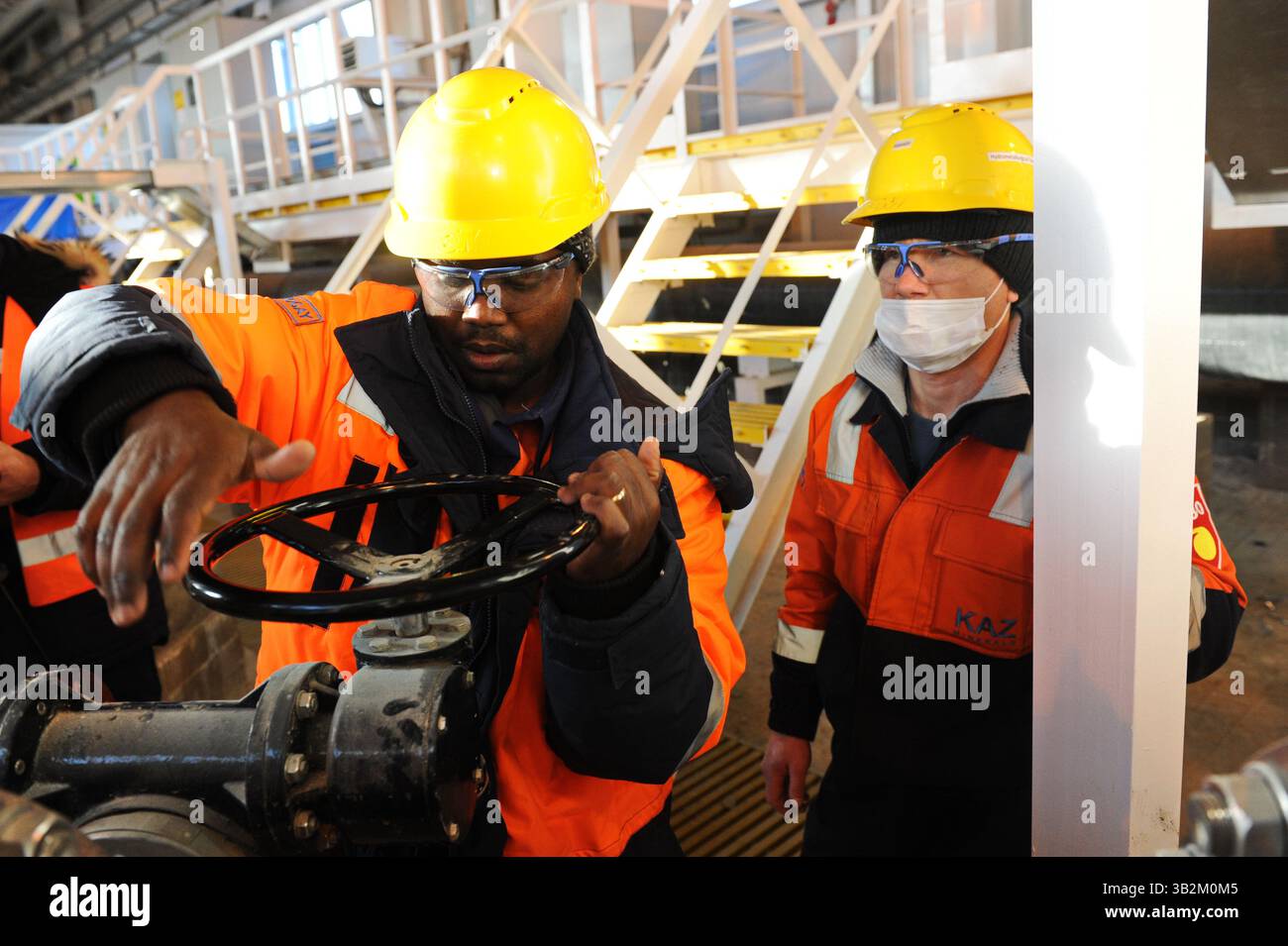 Workers fix and prepare layers of cathode copper at the plant Stock ...