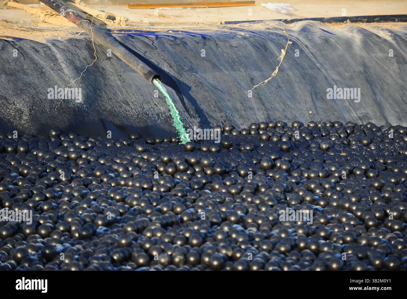The chemical tank is covered with plastic balls to slow evaporation at ...