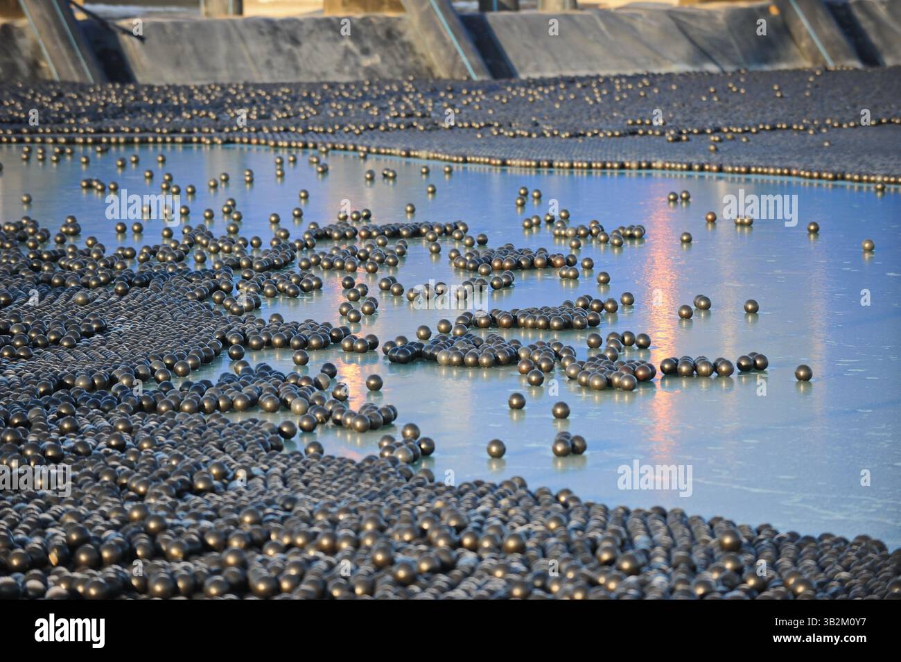 The chemical tank is covered with plastic balls to slow evaporation at ...
