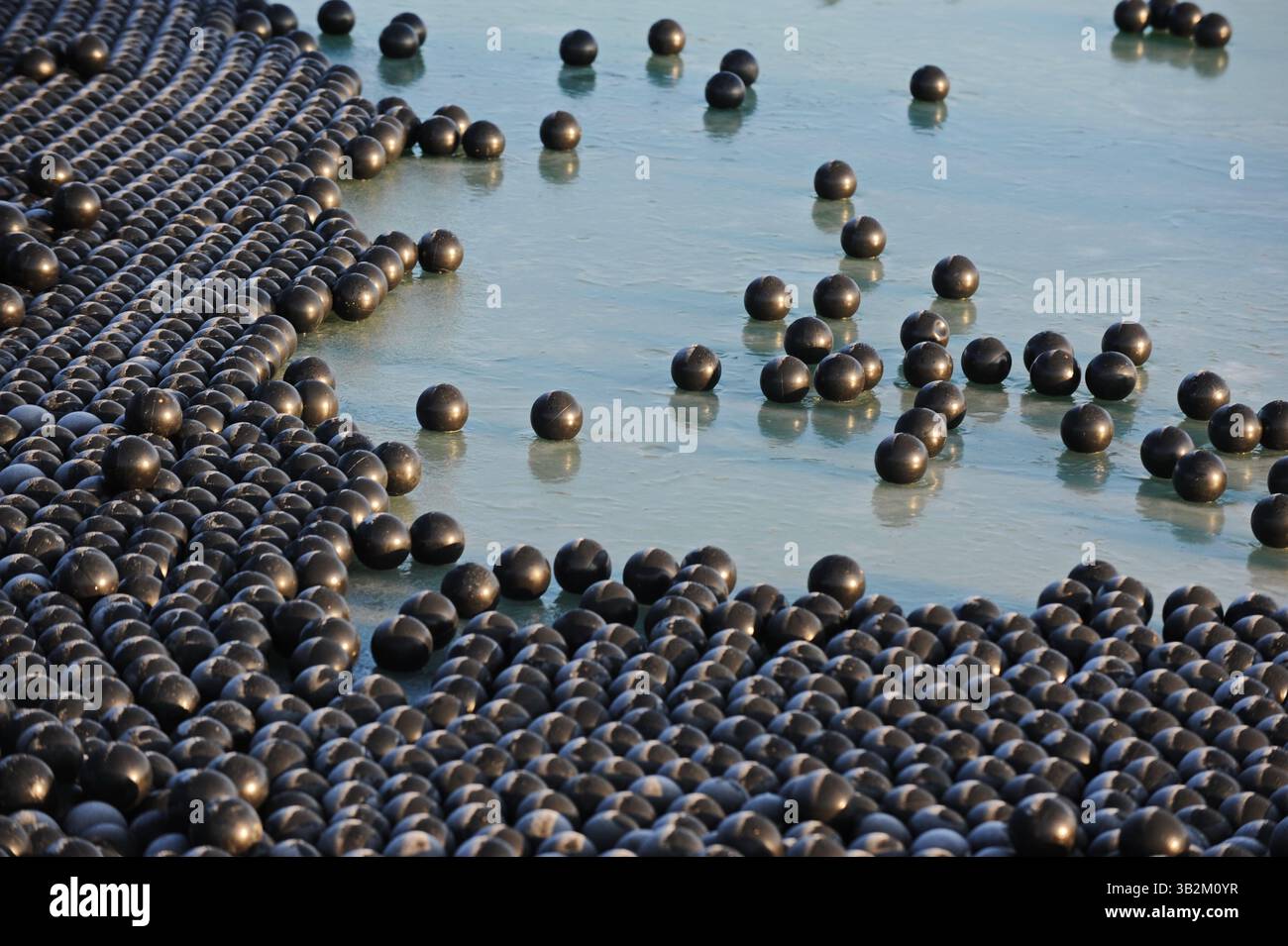 The chemical tank is covered with plastic balls to slow evaporation at ...