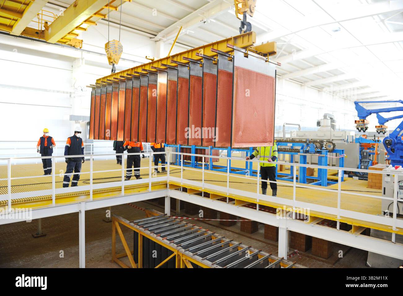 Workers fix and prepare layers of cathode copper at the plant Stock ...