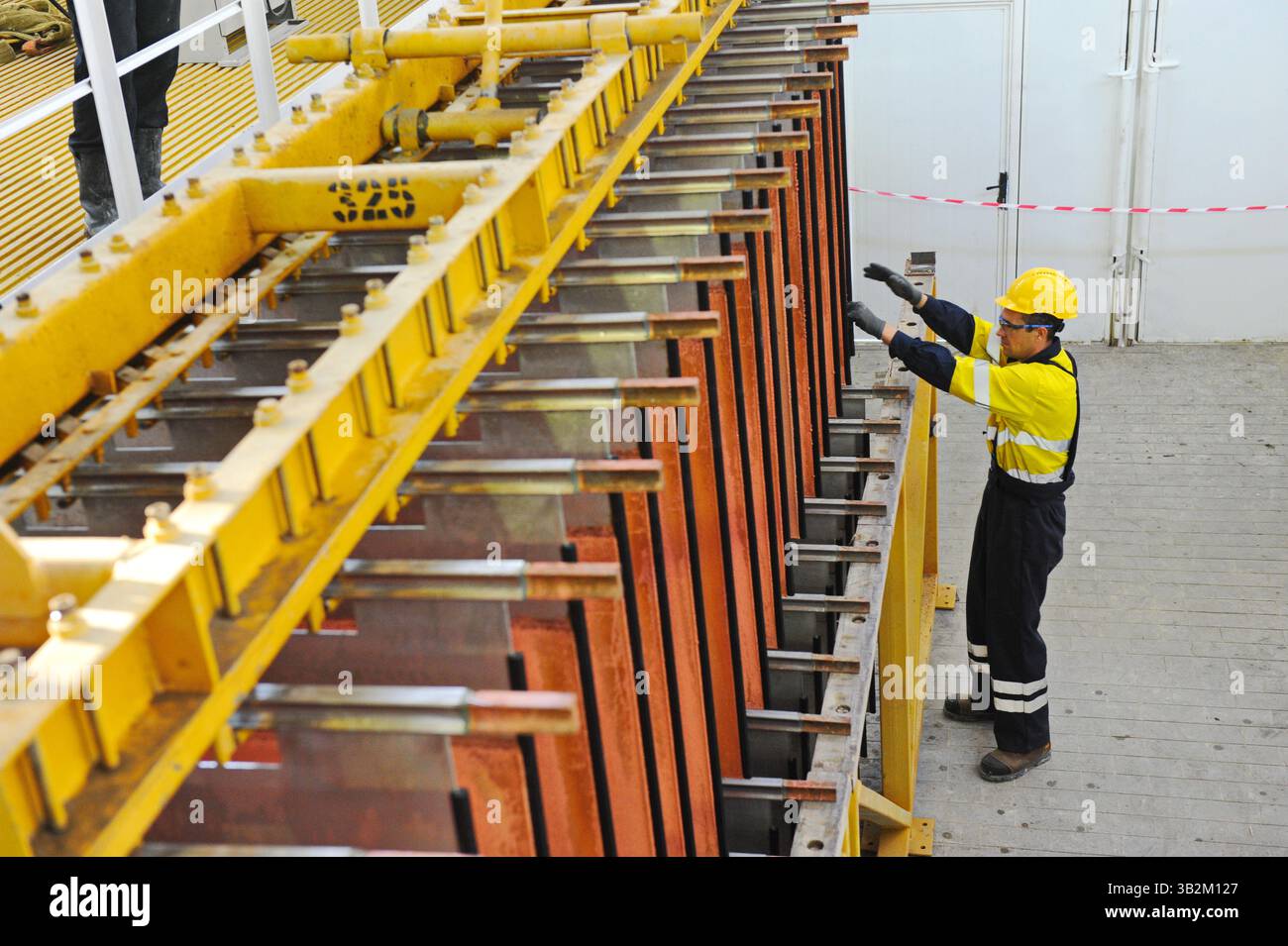 Workers fix and prepare layers of cathode copper at the plant Stock ...