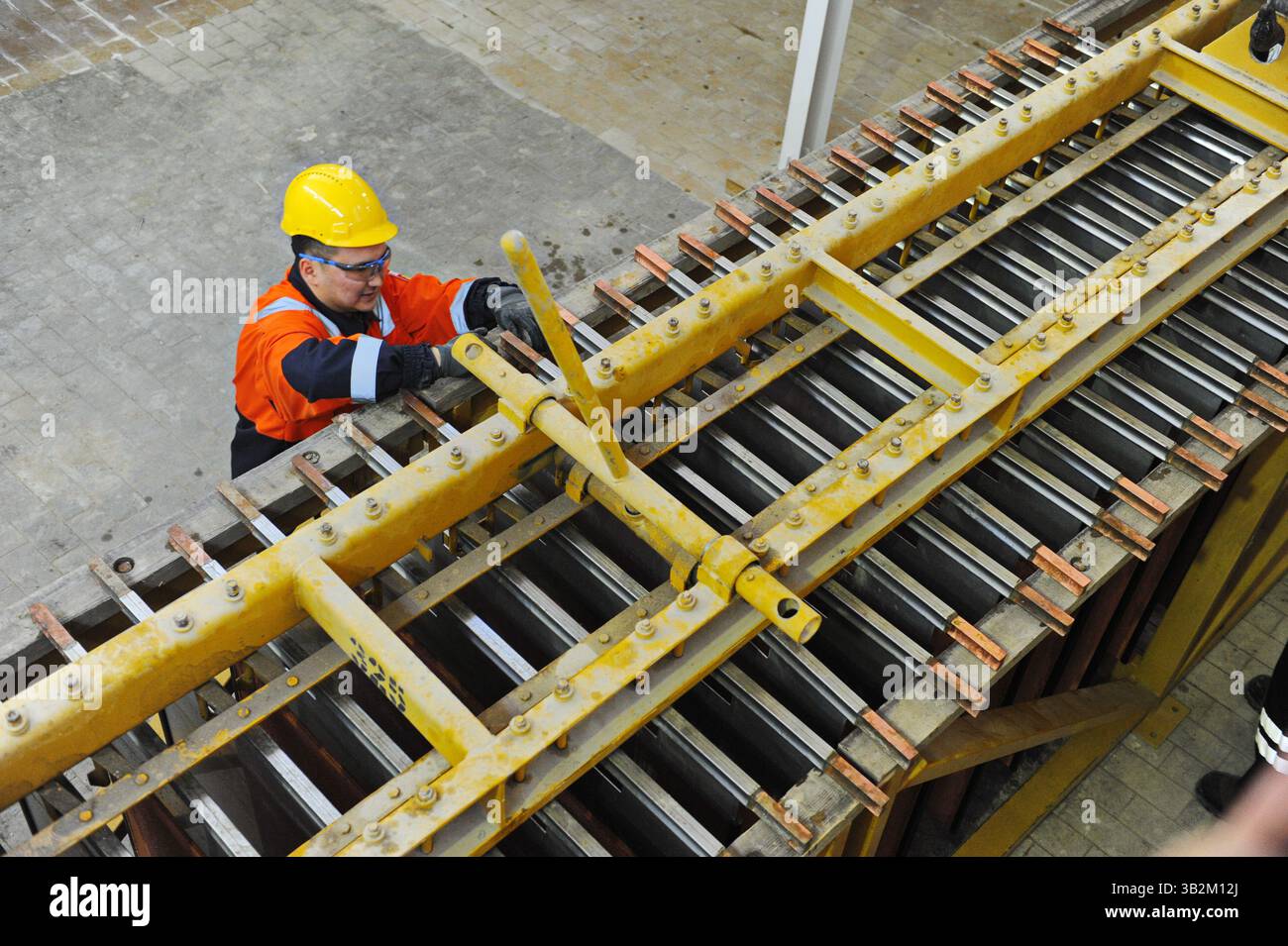 Workers fix and prepare layers of cathode copper at the plant Stock ...