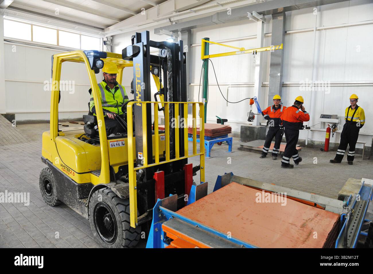 Workers fix and prepare layers of cathode copper at the plant Stock ...