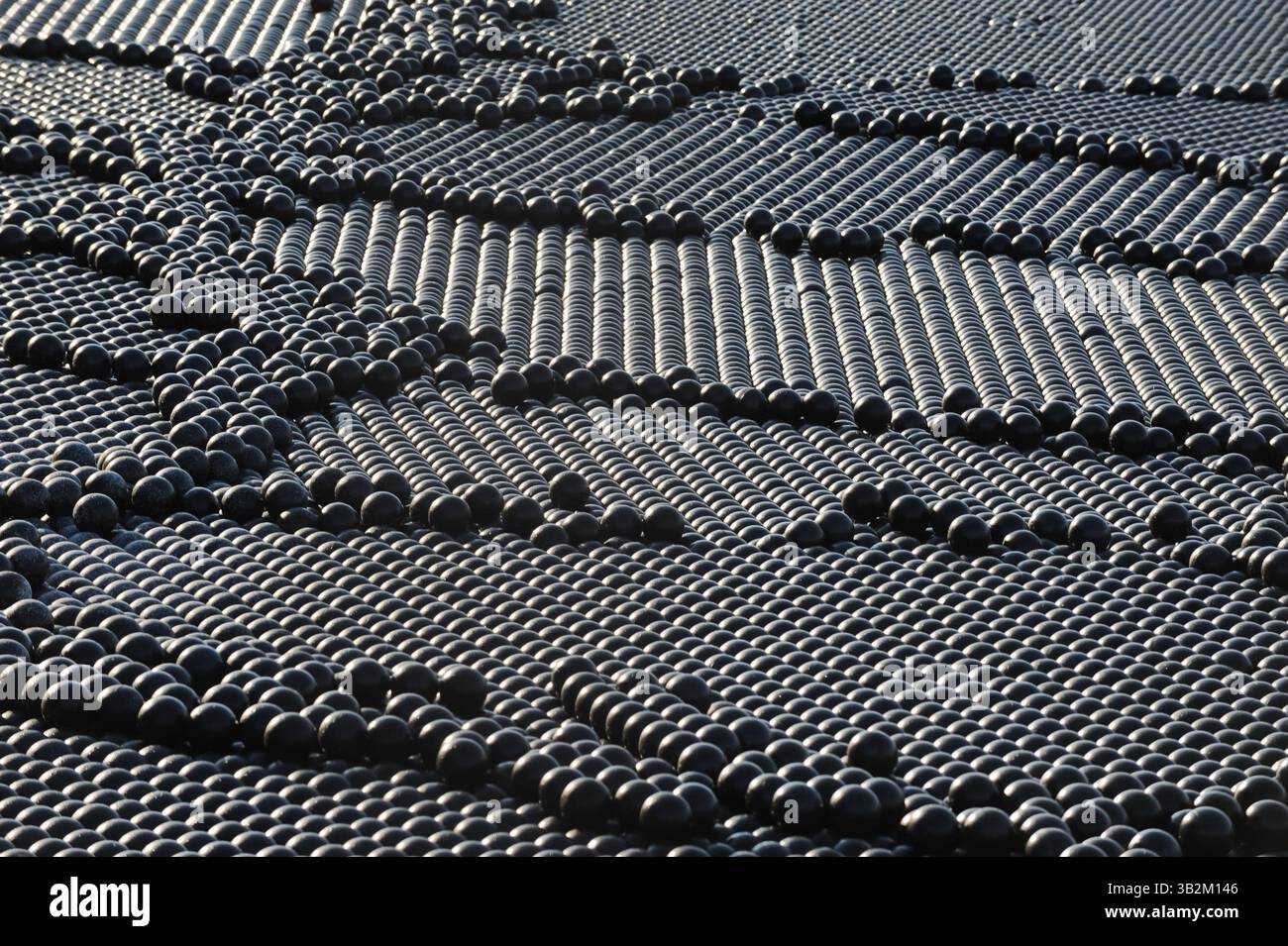 The chemical tank is covered with plastic balls to slow evaporation at ...