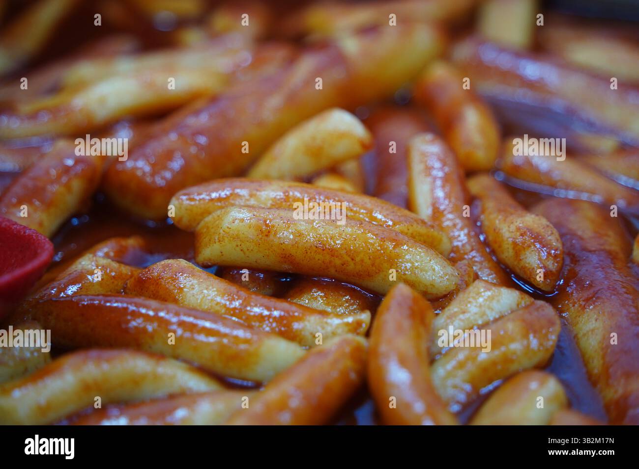 Tteokbokki is a popular Korean dish of chewy rice cakes cooked in a ...