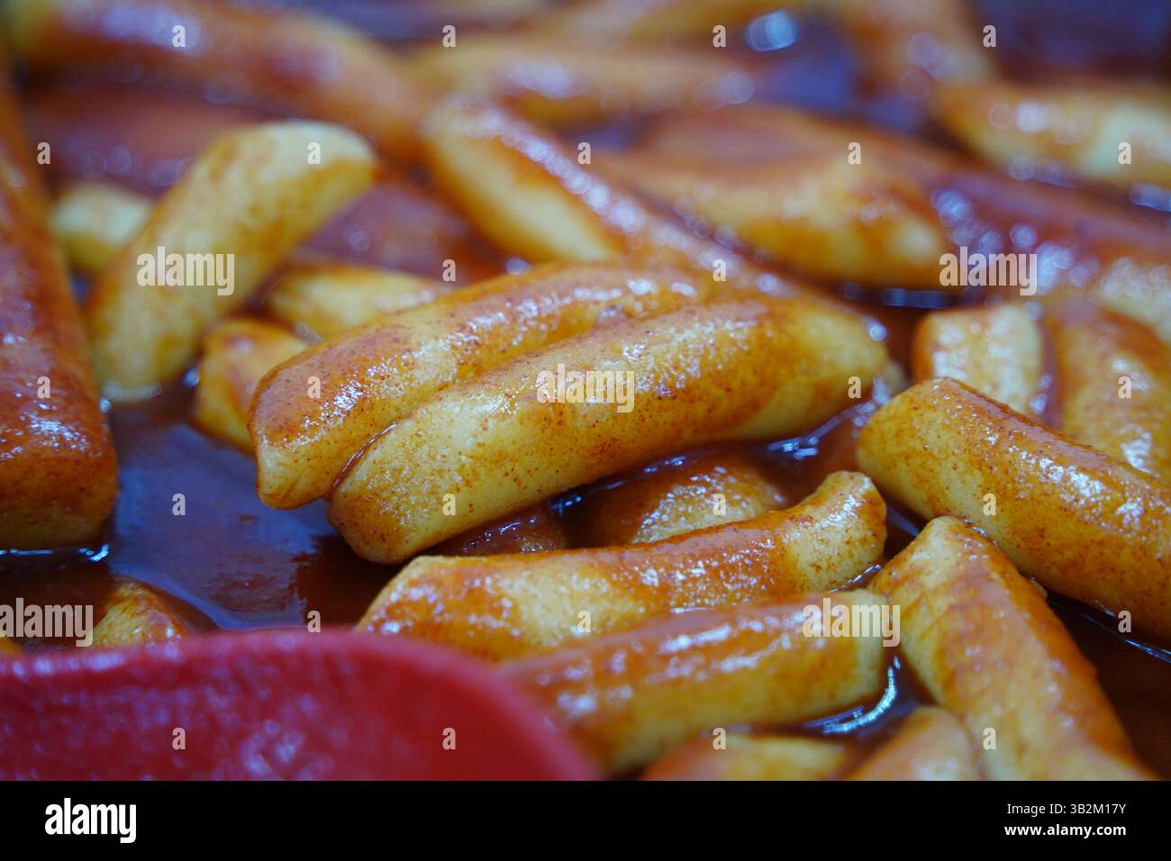 Tteokbokki is a popular Korean dish of chewy rice cakes cooked in a ...