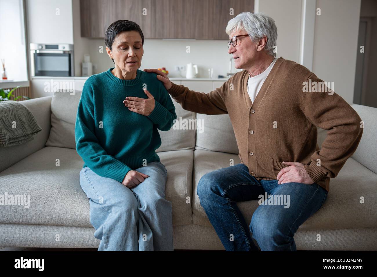 Senior couple health issues. Scared woman struggles with tight chest ...
