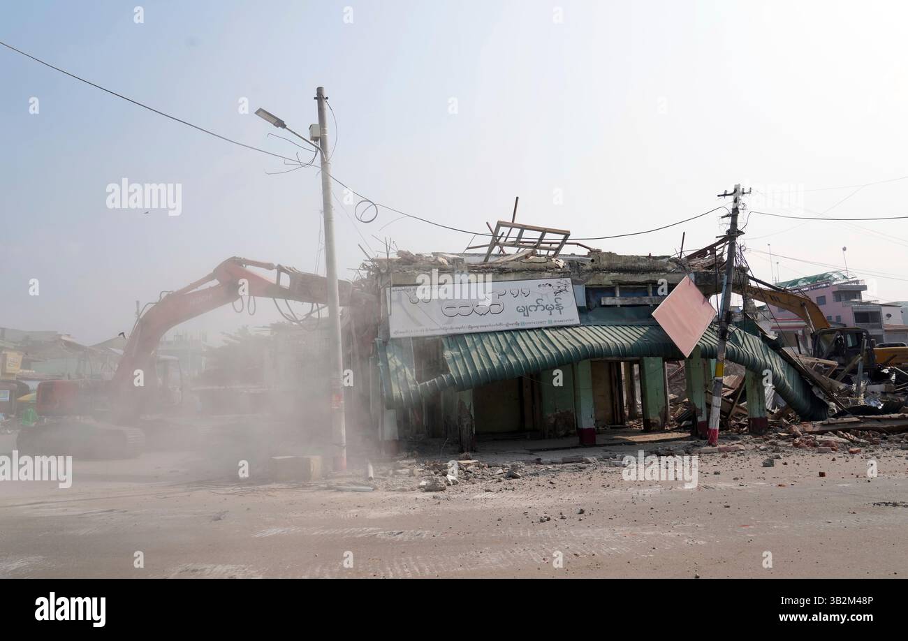 A volunteer drives a backhoe to clear debris of a building at a market ...