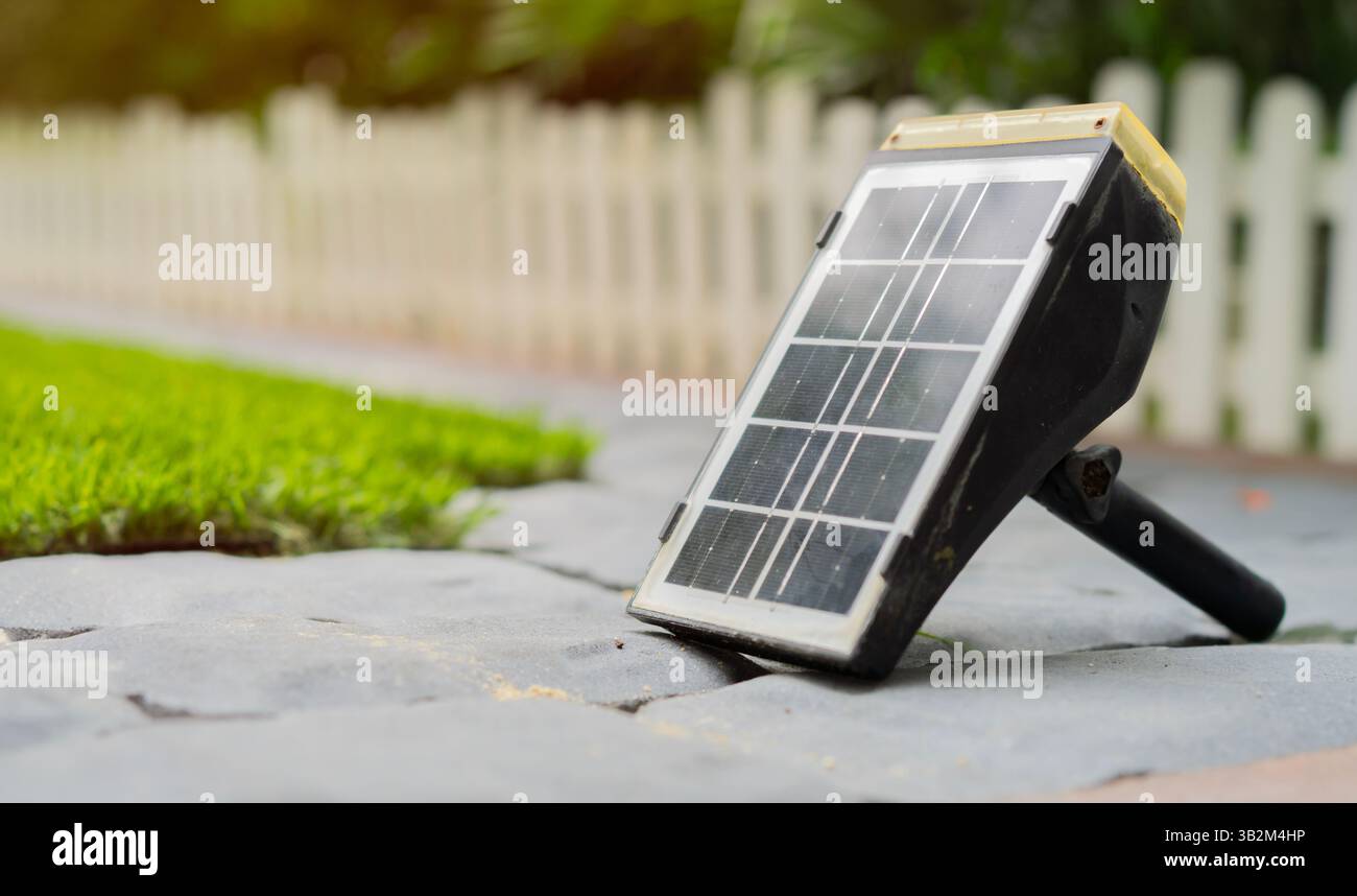 Mini-stand electric solar cell in garden with copy space. Solar panels ...