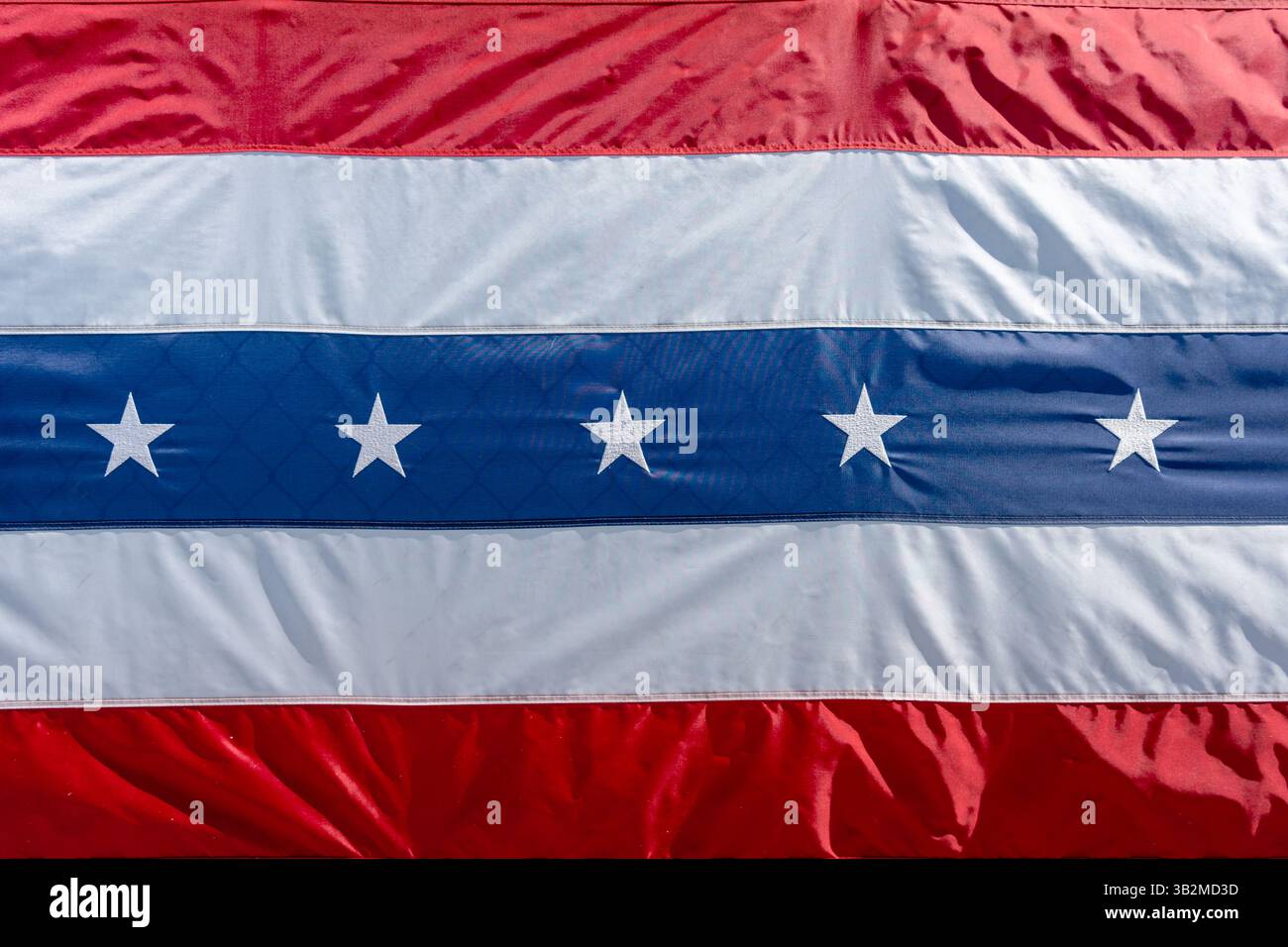 A detailed view of a patriotic flag with red, white, and blue stripes ...