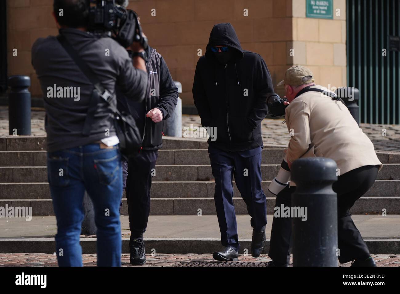 Adam Carruthers (centre) arrives at Newcastle Crown Court where he is ...
