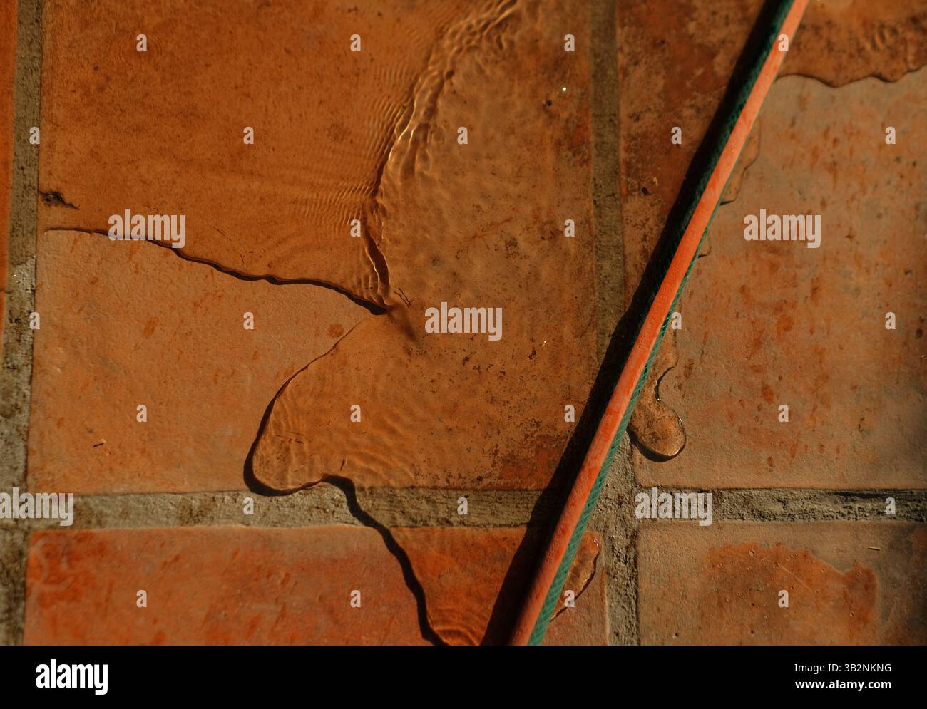 Spilled Water on Terracotta Tiles Stock Photo - Alamy