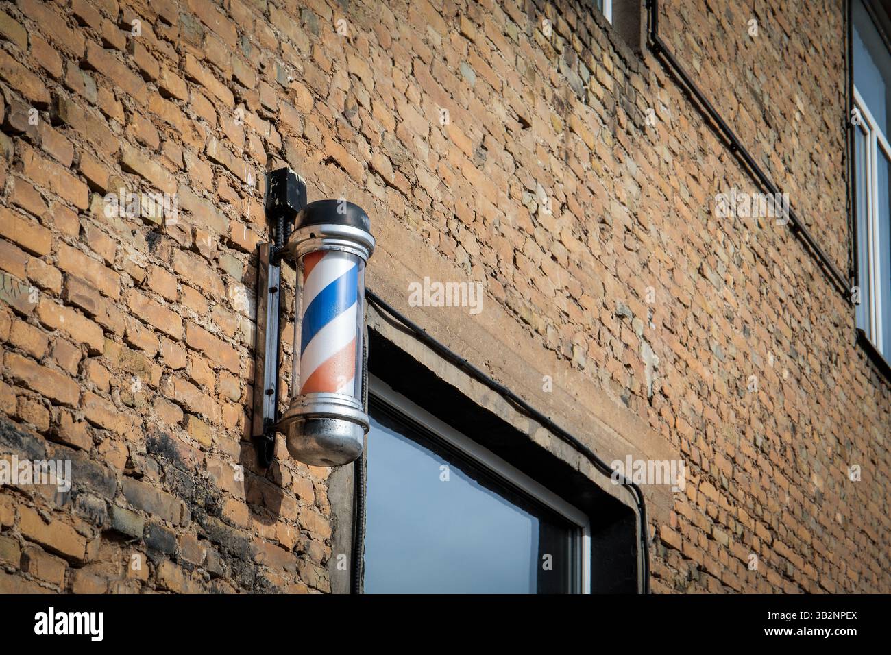 Classic Barber Shop Pole on Brick Wall Stock Photo - Alamy