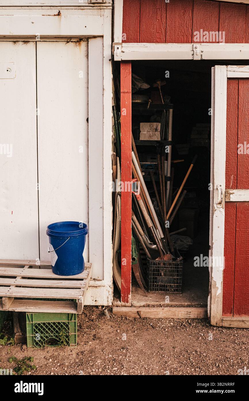 Colorado homestead red barn shed with sliding door with farming tools ...