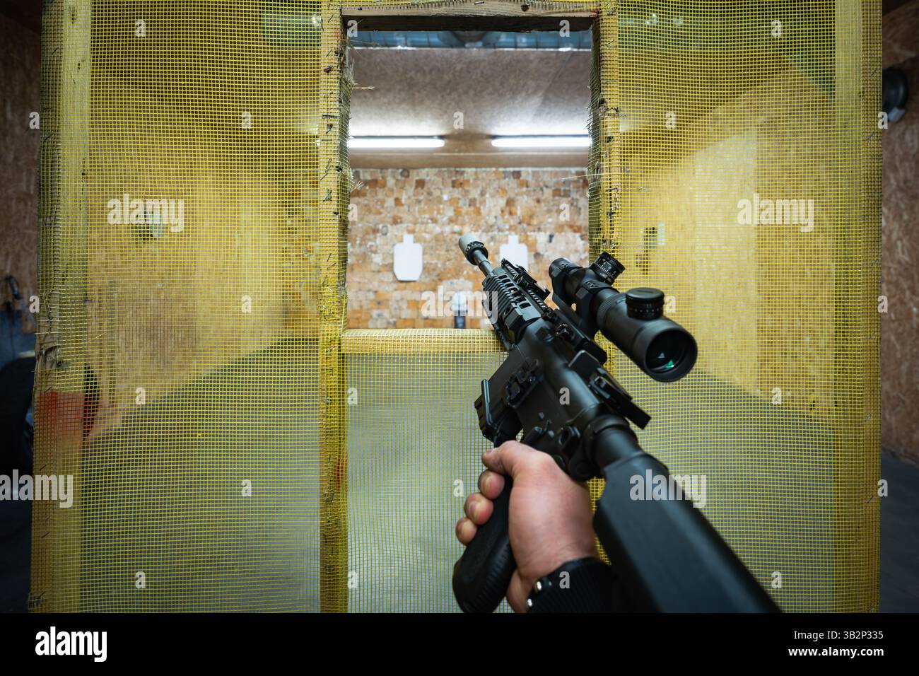 Shooter with a modern semi-automatic rifle with a silencer and an ...