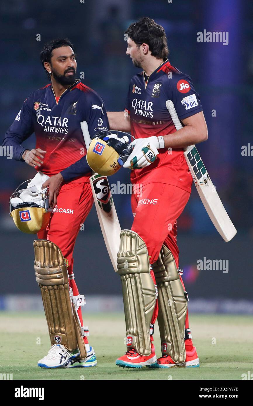 DELHI, INDIA - APRIL 27: Krunal Pandya of Royal Challengers Bengaluru (L) and Tim David of Royal ...