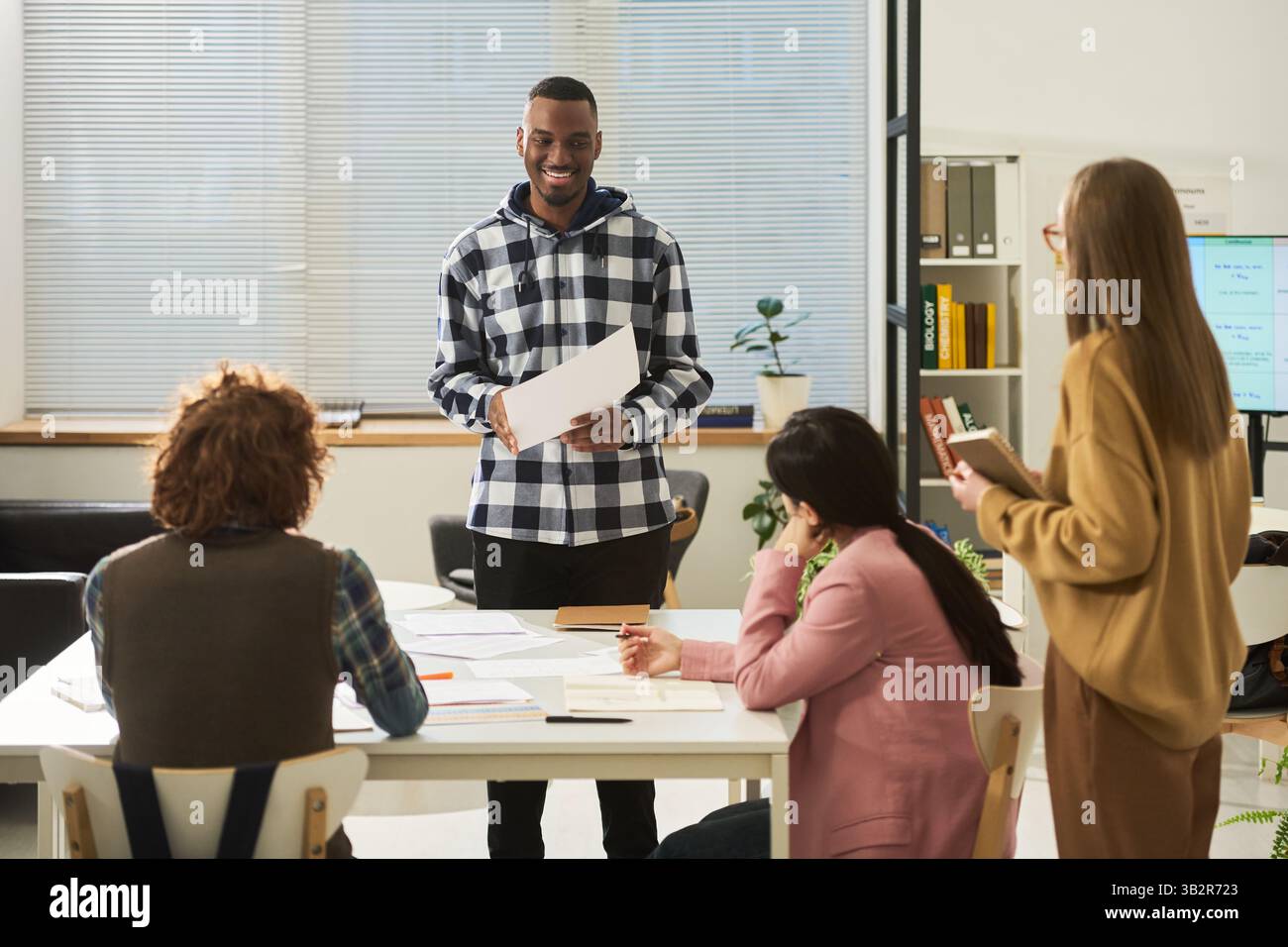 Smiling Man Teaching Foreign Language in Classroom Setting Stock Photo ...