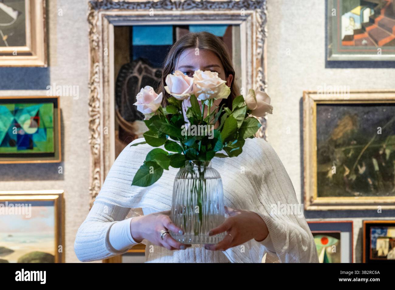 London, UK. 28 April 2025. A staff member with roses in front of lots ...
