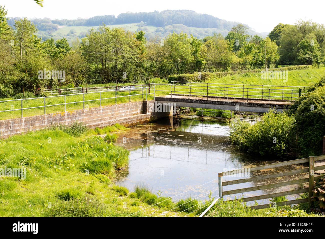 cement bridge and brick wall next to a flood defence area and river ...