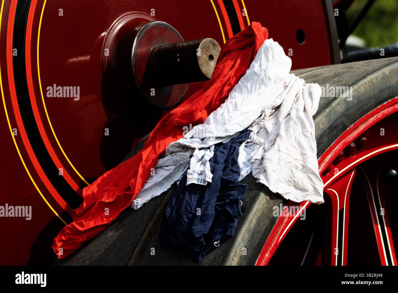 cleaning rag and close up detail of a red and black traction engine or ...