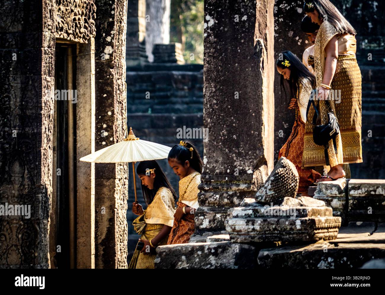 A group of women in traditional attire walking down ancient stone steps ...