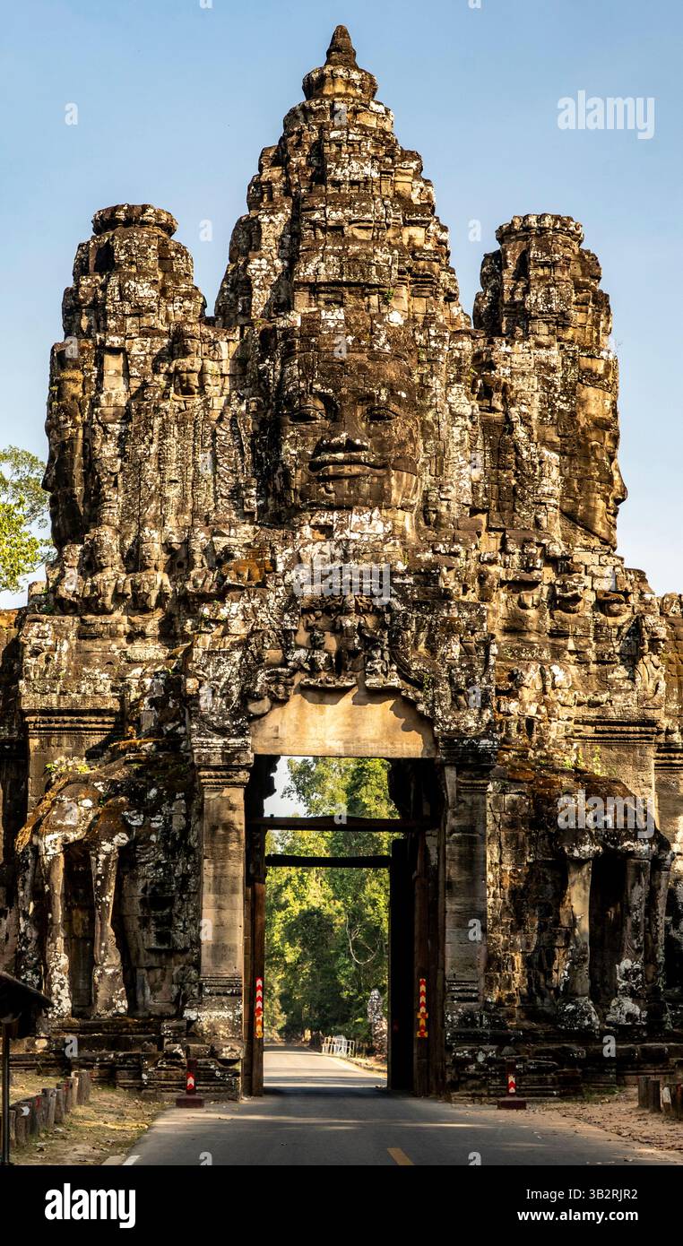 A majestic ancient stone gate with intricate carvings and a large face ...