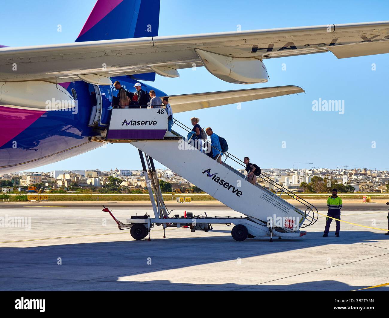 Wizzair plane, passengers boarding at Malta airport Stock Photo - Alamy