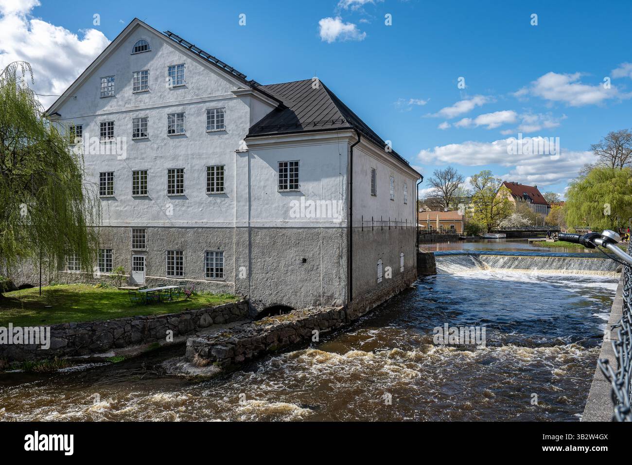 The old mill Akademikvarnen and river Fyrisån in Uppsala, Sweden at the ...