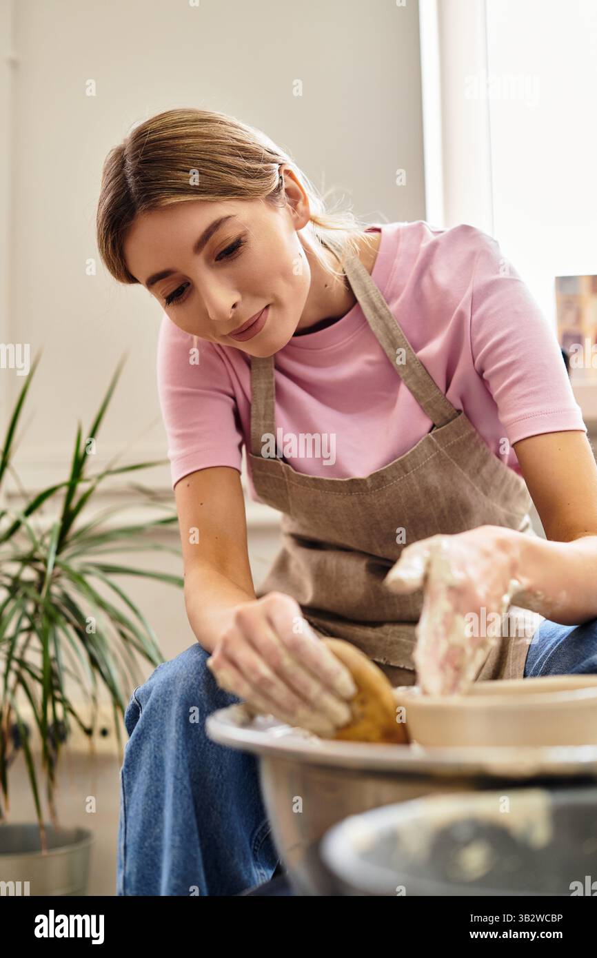 A dedicated artisan molds clay into a beautiful pottery piece ...