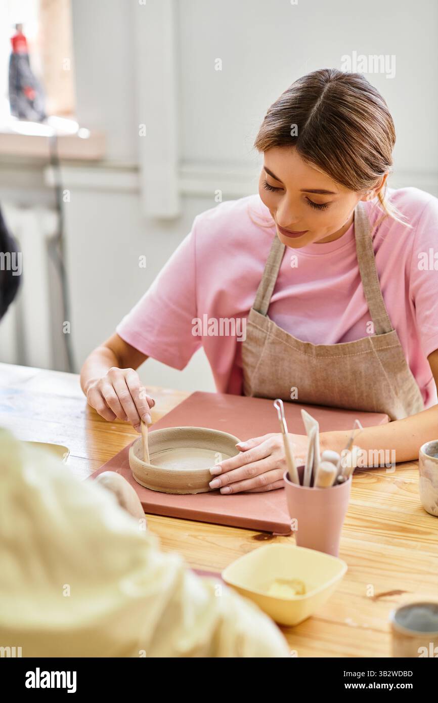 A young couple enjoys pottery making together, focusing on their ...