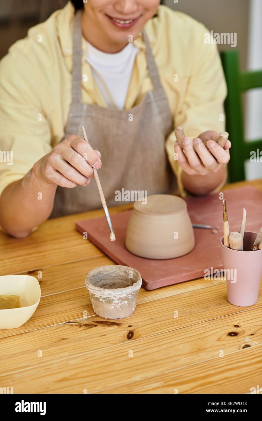 In a vibrant pottery studio, a skilled artist shapes clay with care while exploring creativity ...