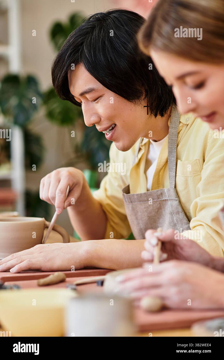 Young couple engaged in pottery making, sharing smiles and creating art ...