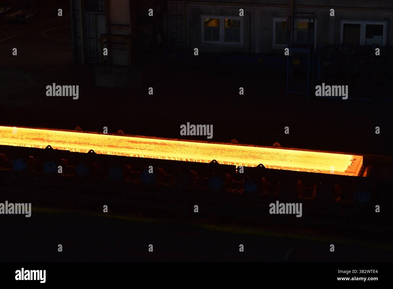glowing brame in a steel mill - industrial factory for the production ...