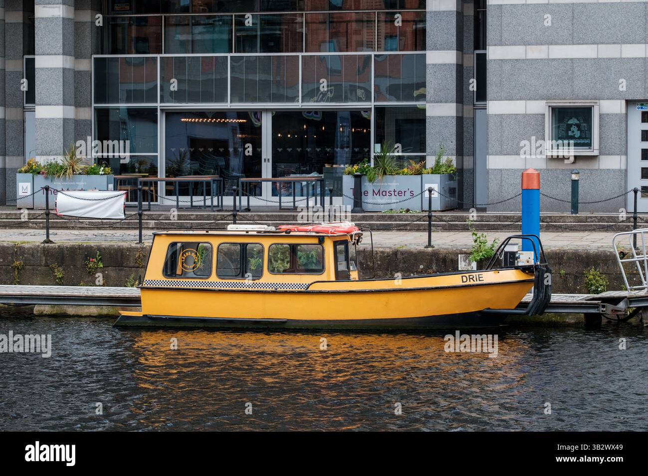 Leeds UK: 3rd June 2024: A bright yellow water taxi is docked along the ...