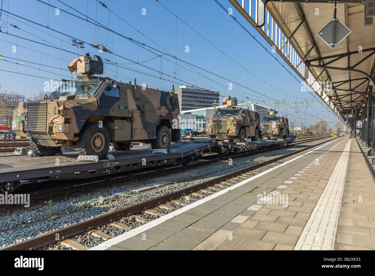 Military armored vehicles on a freight train at a European railway ...