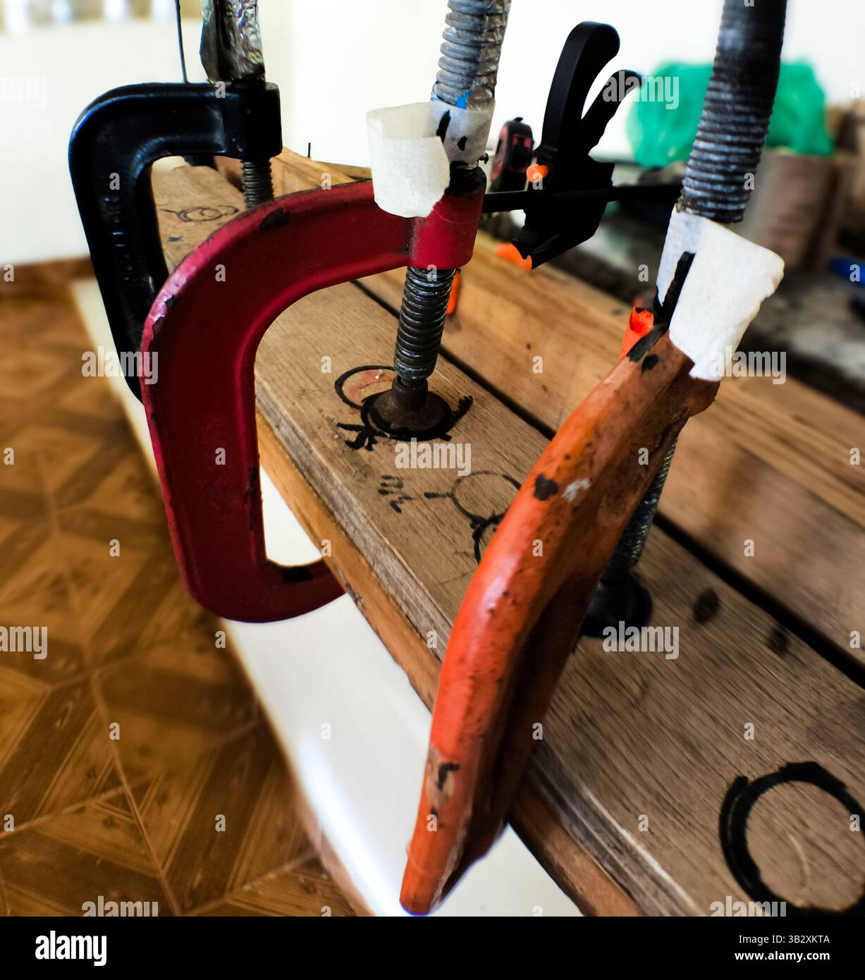 Set of clamps for gluing wood Stock Photo - Alamy