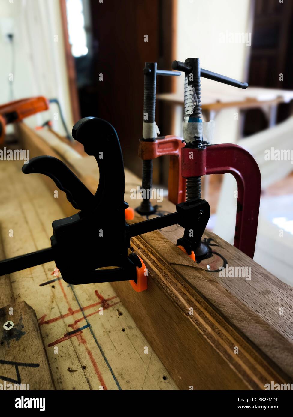 Set of clamps for gluing wood Stock Photo - Alamy