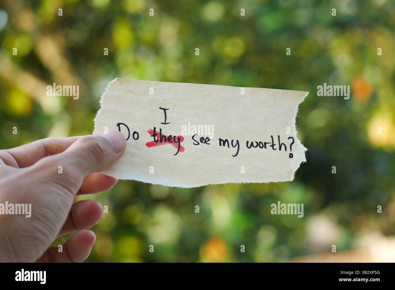 hand holding a note paper with the words Do They See My Worth ...