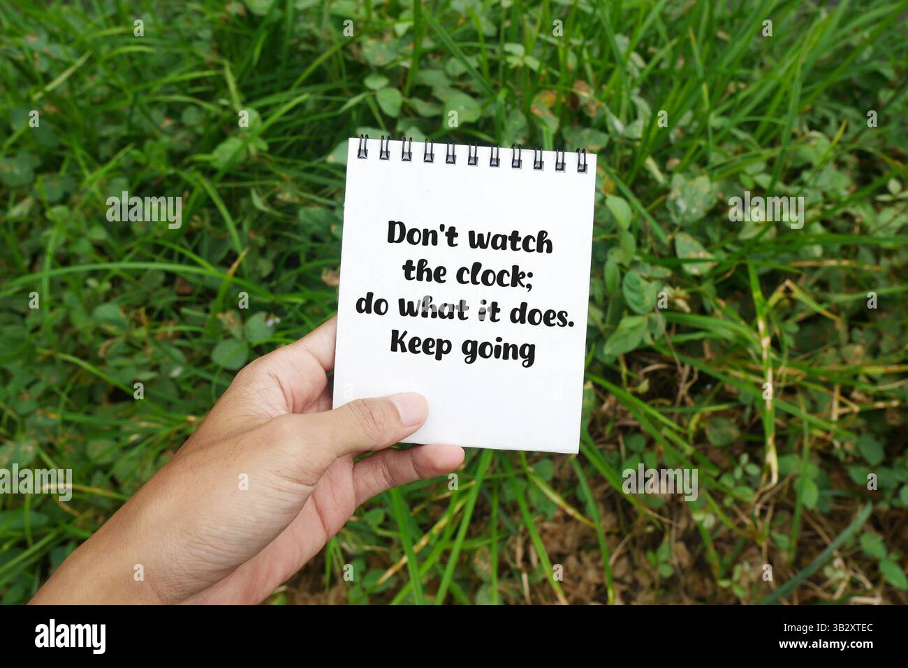 Notebook with motivational quote 'Don't watch the clock; do what it ...