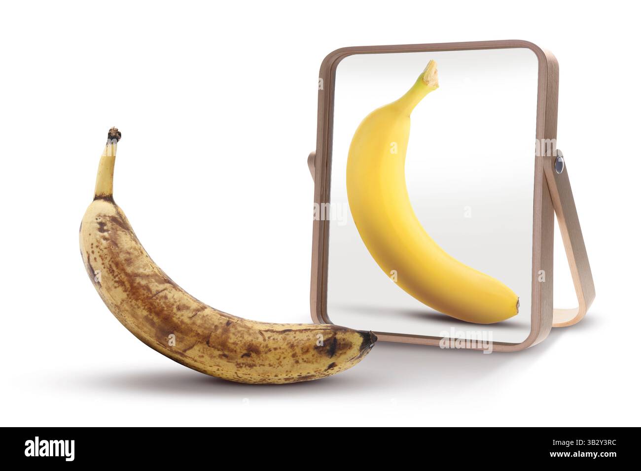 Banana with dark spots reflected in mirror as clean, white background ...