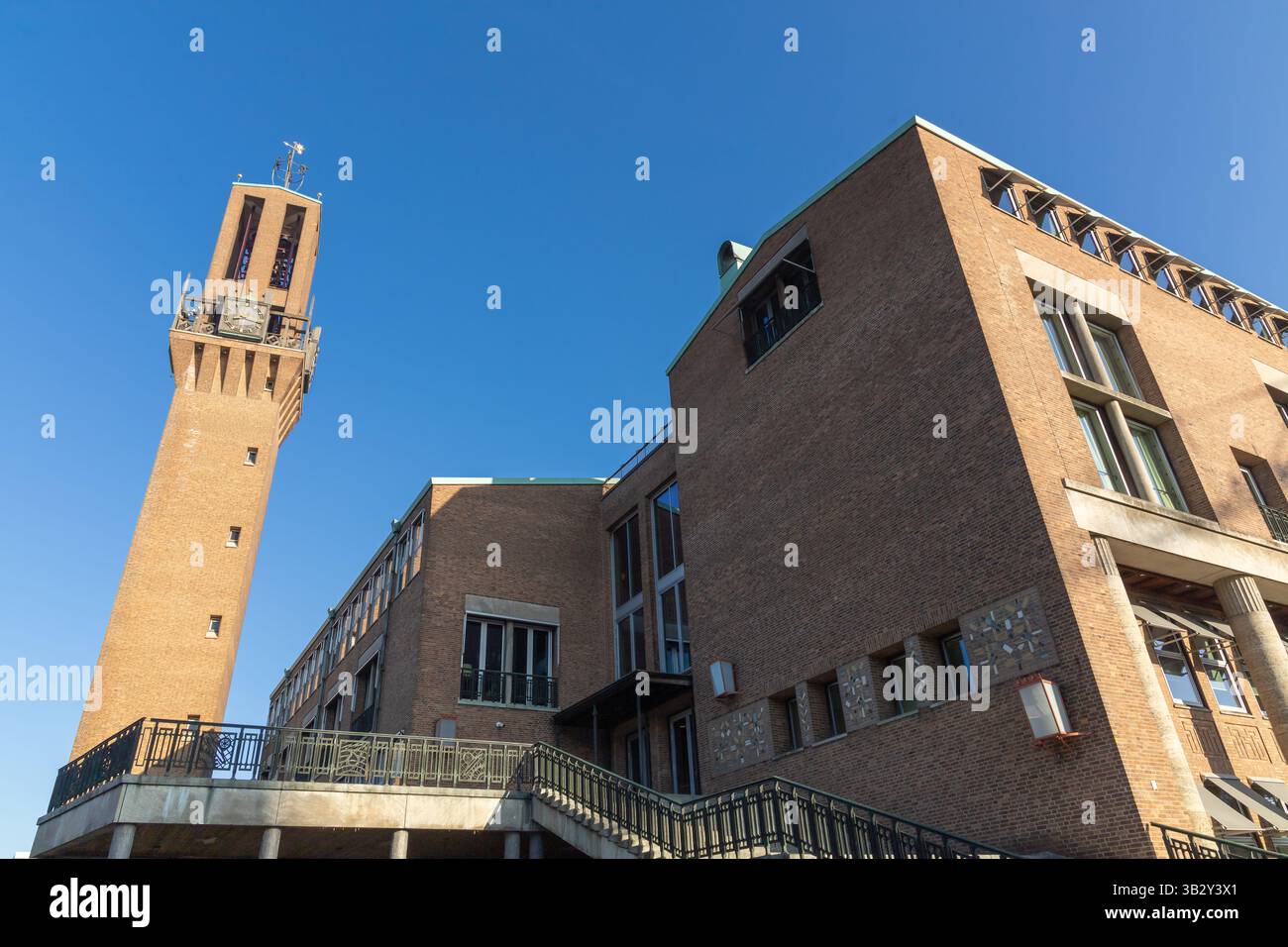 Hengelo city hall building with a tall clock tower under a clear blue ...