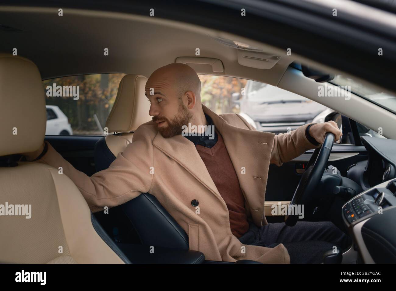 Man focusing on safe driving while reversing a vehicle with care Stock ...