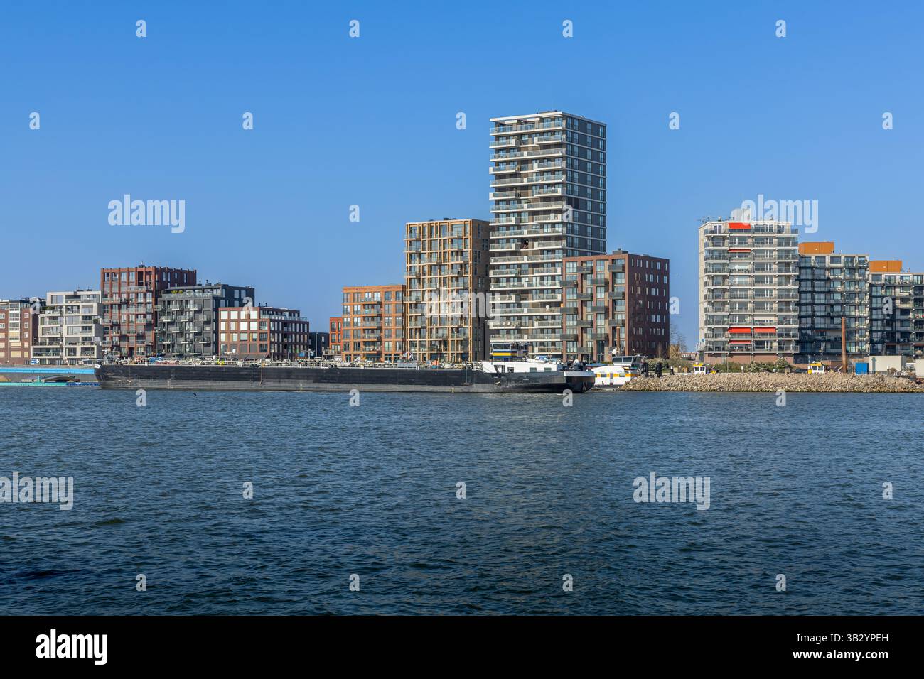 Modern buildings across the river "oude maas" from the old historic ...