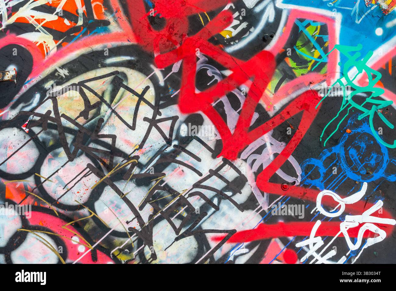Colorful graffitis and tags on a street wall, vibrant urban background ...