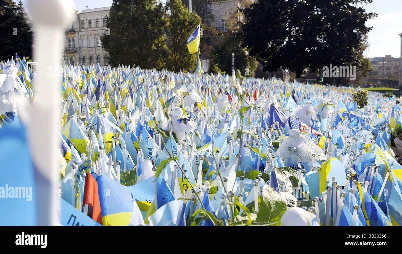 Many small blue-yellow flags with names of the dead war against russia ...