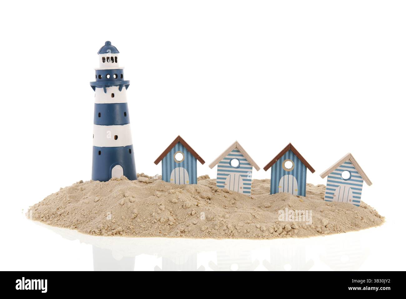 Striped huts and blue with white lighthouse at the beach Stock Photo ...